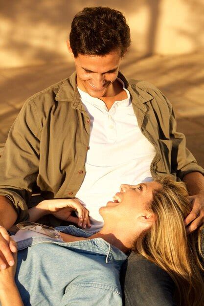 Close Up Happy Woman Lying Head In Lap Of Date Outside Premium Photo
