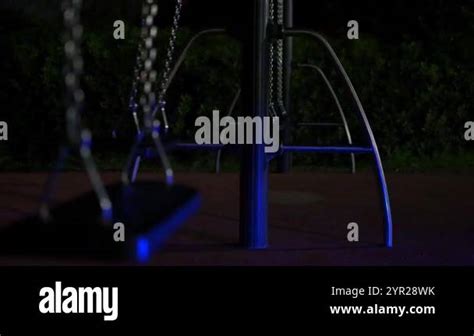 Static Shot Footage Shows A Swinging Empty Swing At A Public Park At