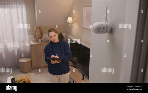 Caucasian Woman Installs Security Camera Woman Sets Up Angle Of Cctv
