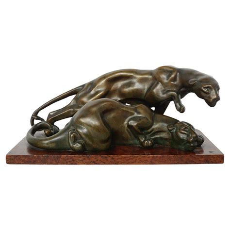 An Art Deco Bronze Sculpture Group Depicting Two Prowling Panthers For