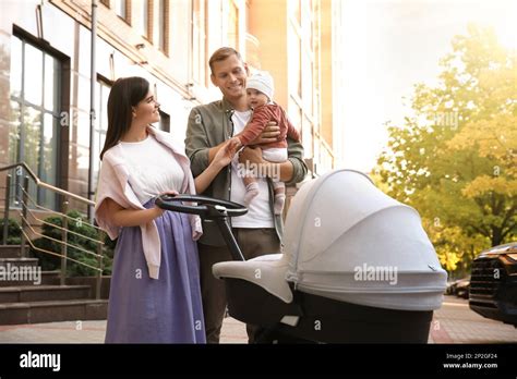 Happy Parents Walking With Their Baby Outdoors Stock Photo Alamy