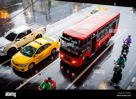 Cars Vans Buses And Motorbikes All Pass Along A Busy Intersection On