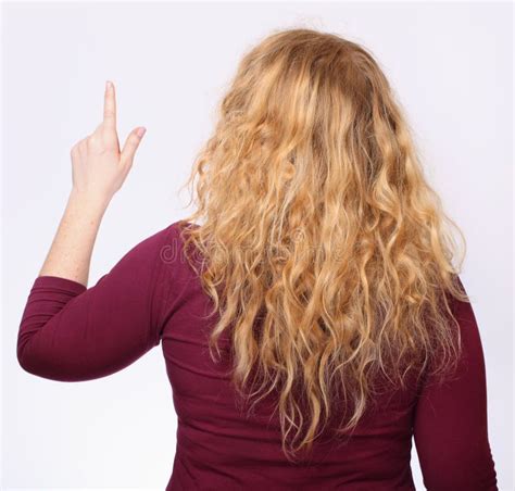 Kinky Redhead Woman Posing In Red Latex Dress And Black Rubber Corset On White Egg Chair