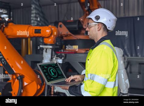 Engineer Male Using Laptop Computer Control Operate Industry Robot Arm Machine Man Programming