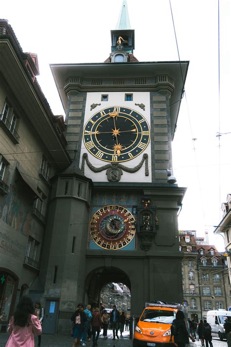A Large Clock Tower With A Clock On Its Side Photo Free Building