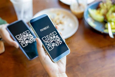 hands holding mobile phone hand using mobile phone application to scan qr code qr code payment