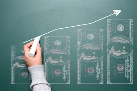 female hand drawing a graph with increasing numbers on a green school