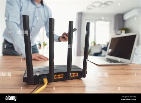 Man Using Modern Wi Fi Router On Light Table In Room Stock Photo Alamy