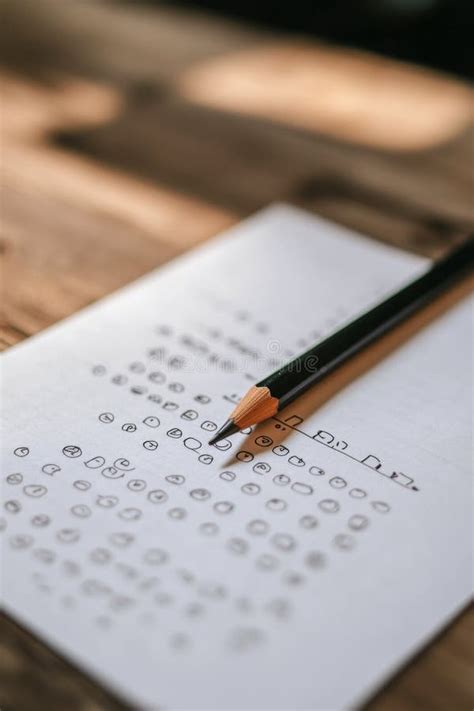 close up of a sharpened pencil marking checkboxes on a printed form or sheet of paper stock
