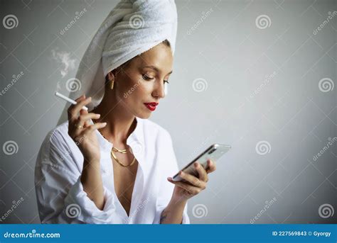 Beautiful Young Woman Smoking Cigarette And Text Messaging While