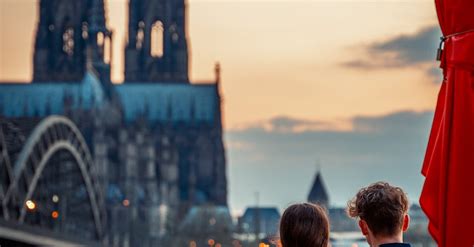 Young Couple Sitting On The Promenade Along The Rhine Near The Gothic Cologne Cathedral · Free