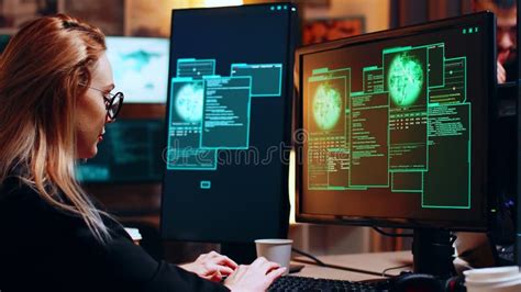 Girl Hacker Looking At Super Computer With Multiple Monitors Stock