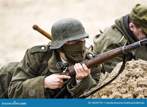 A German Soldier In A Trench With A Rifle In His Hand Historical
