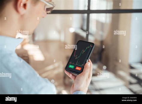 Close Up View Image Of Man Checking Bitcoin Price Chart On Digital Stock Market App On