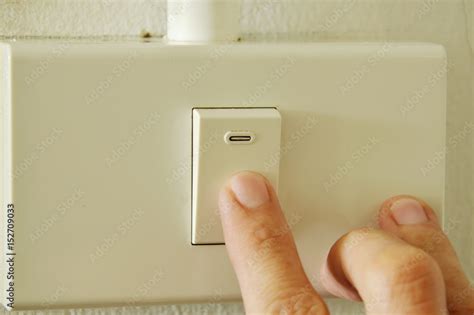 Human Finger Closed Toggle Switch In Plastic Box On Wall Stock Photo Adobe Stock