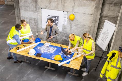 Premium Photo Contractor And Architects Analyzing Plans And Blueprints Of The New Project At