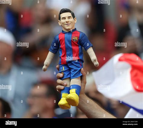 A Spectator Holds A Doll Of Lionel Messi Just Before The Match Of The