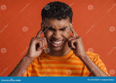 Young Tense African Man With Closed Eyes Touching His Tamples Stock