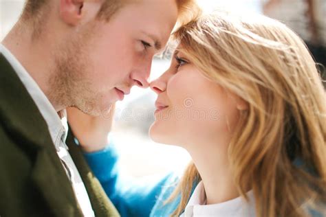 Young Happy Blonde Couple Kissing And Hugging On City Street Stock
