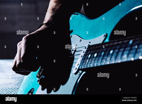 Man Playing Blue Electric Guitar Close Up Practicing Guitar And