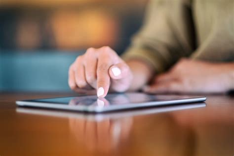 Premium Photo Closeup Image Of A Woman Pointing Finger At Tablet Pc On Wooden Table