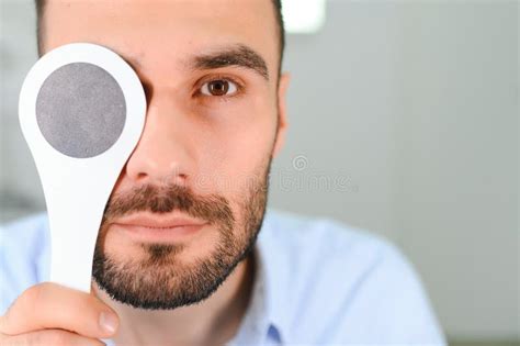 Test Of Sight Man Is Checking His Vision Indoors In The Clinic Stock