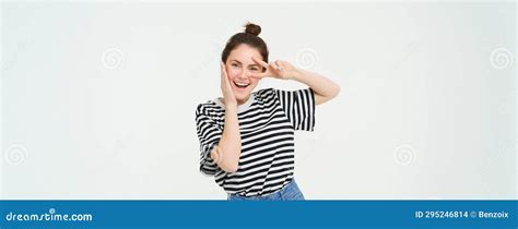Cute European Woman Posing For Photo Holding Peace Kawaii Hand Gesture Near Face Smiling At