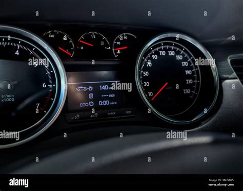 Detailed View Of A Modern Car Dashboard Showing Illuminated Tachometer Speedometer Fuel Gauge