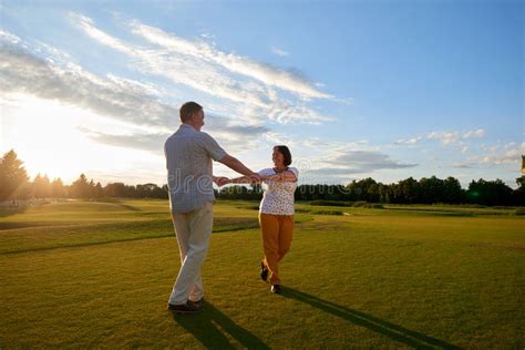 Happy Mature Couple Holding Hands On The Field Stock Image Image Of