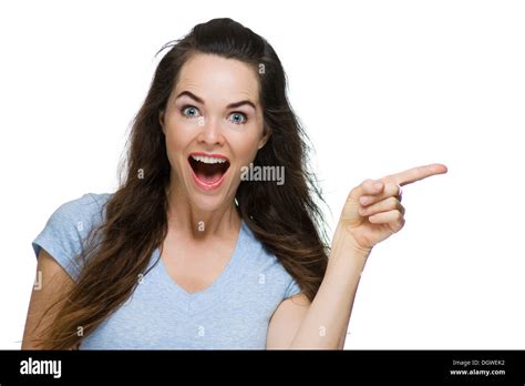 A Very Happy And Surprised Woman Pointing To Copy Space Isolated On