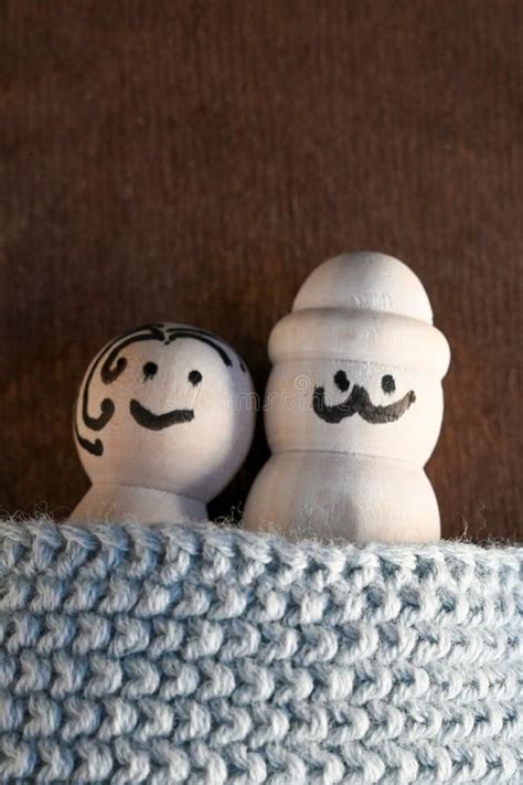 Wooden Peg Dolls Symbolizing Man And Woman Under A Duvet In Bed Stock