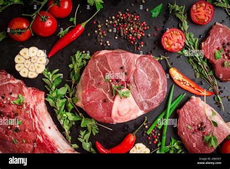 Different Types Of Steaks Set Assorted Raw Meat On A Black Chalk Board