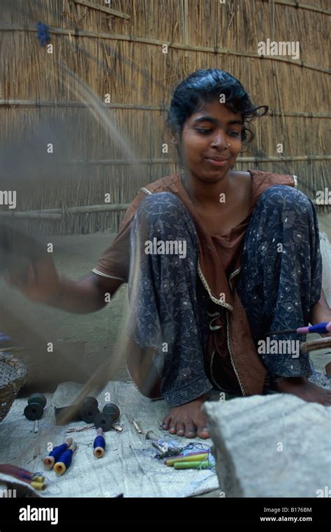 Woman Spinning Drying And Making Cotton Thread For Weaving In A Village In Bangladesh Stock