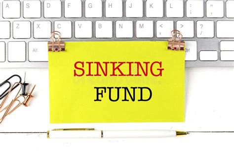 sinking fund concept with yellow note keyboard pen and office