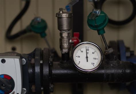Premium Photo Round Thermometer On A Pipe In The Boiler Room