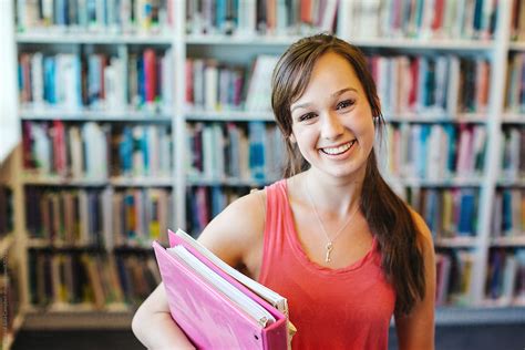 Portrait Of Happy High School Teenage Girl Holding Book Binder In