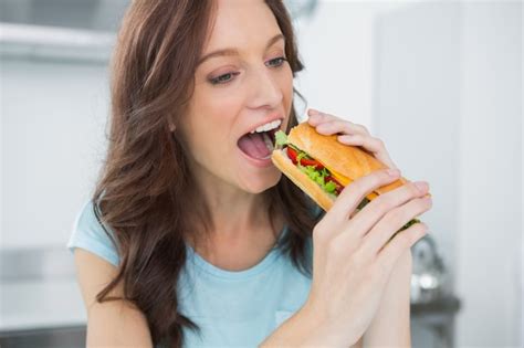 Premium Photo Pretty Brunette Eating Sandwich