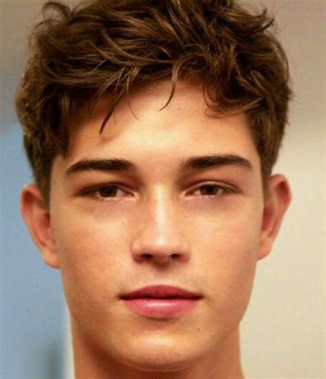 A Close Up Of A Young Man With Short Hair