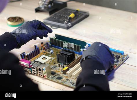 Inserting Ram Into Motherboard From Computer On Table And Gray Background Stock Photo Alamy