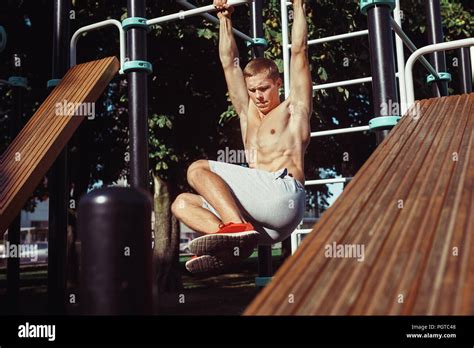 The Fit Athlete Doing Exercises At Stadium Caucasian Young Man Outdoor