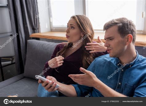 Girl Sitting Sofa Man Pointing Hand Remote Controller Air Conditioner Stock Photo By HayDmitriy