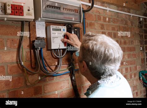 Elderly Woman Using A Quantum Key Prepayment Electric Meter And Checking The Amount Of Credit Left