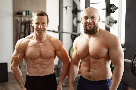 Premium Photo Two Shirtless Men Standing In Gym Young Man And His