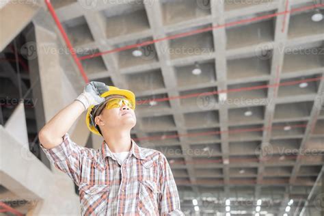 Young Man Construction Worker Engineer Or Architect Holding Plan On A Construction Site