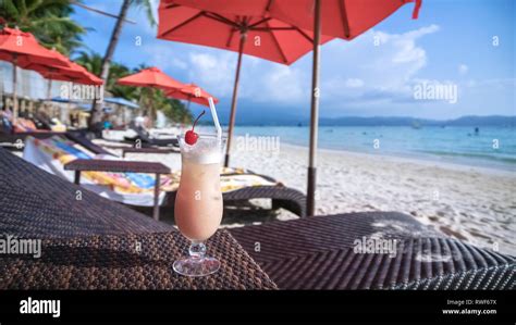 Tropical Cocktail With Cherry By Red Beach Umbrellas Boracay Island