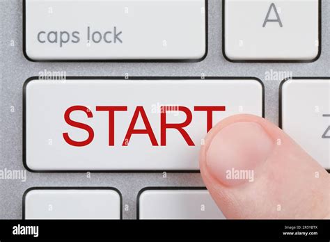 Woman Pressing Button With Word Start On Computer Keyboard Closeup Stock Photo Alamy