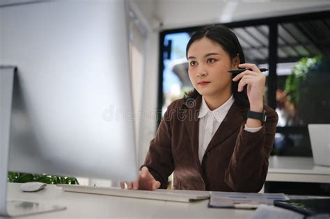 Concentrated Female Economist Looking At Computer Display Analyzing