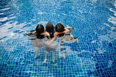 Three Asian Teenage Girls Playing Inside A Swimming Pool Stock Image