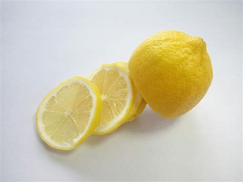 Premium Photo Close Up Of Lemon Slice Against White Background
