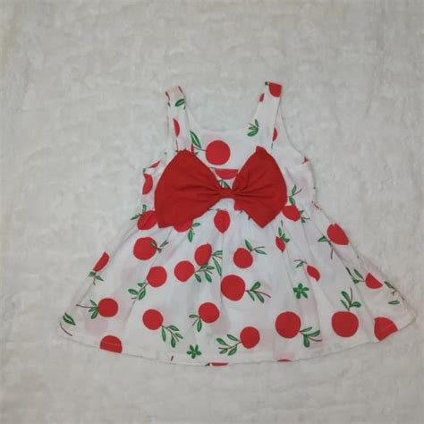 کمدا قیمت و خرید پیرهن مجلسی ، با کلاه ست رنگ سفید با توپ های قرمز پ